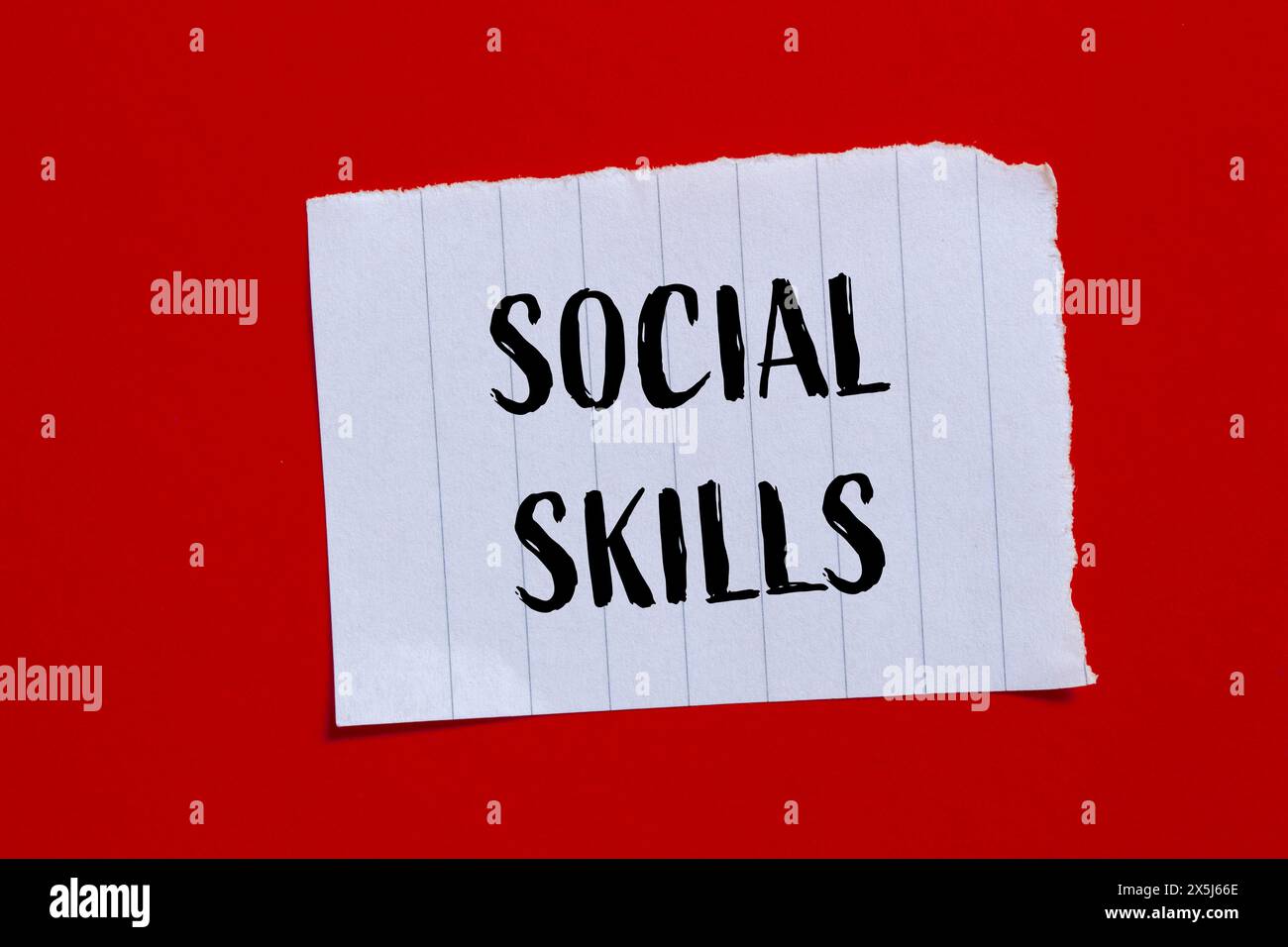Social skills words written on ripped paper with red background ...