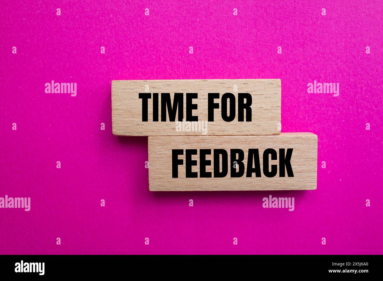 Time for feedback words written on wooden blocks with pink background ...