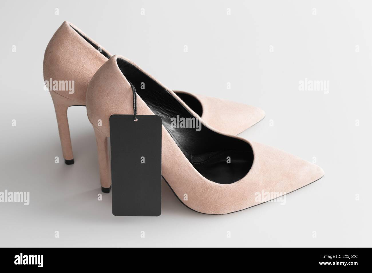 Soft pink high heels with black price tag mockup Stock Photo - Alamy