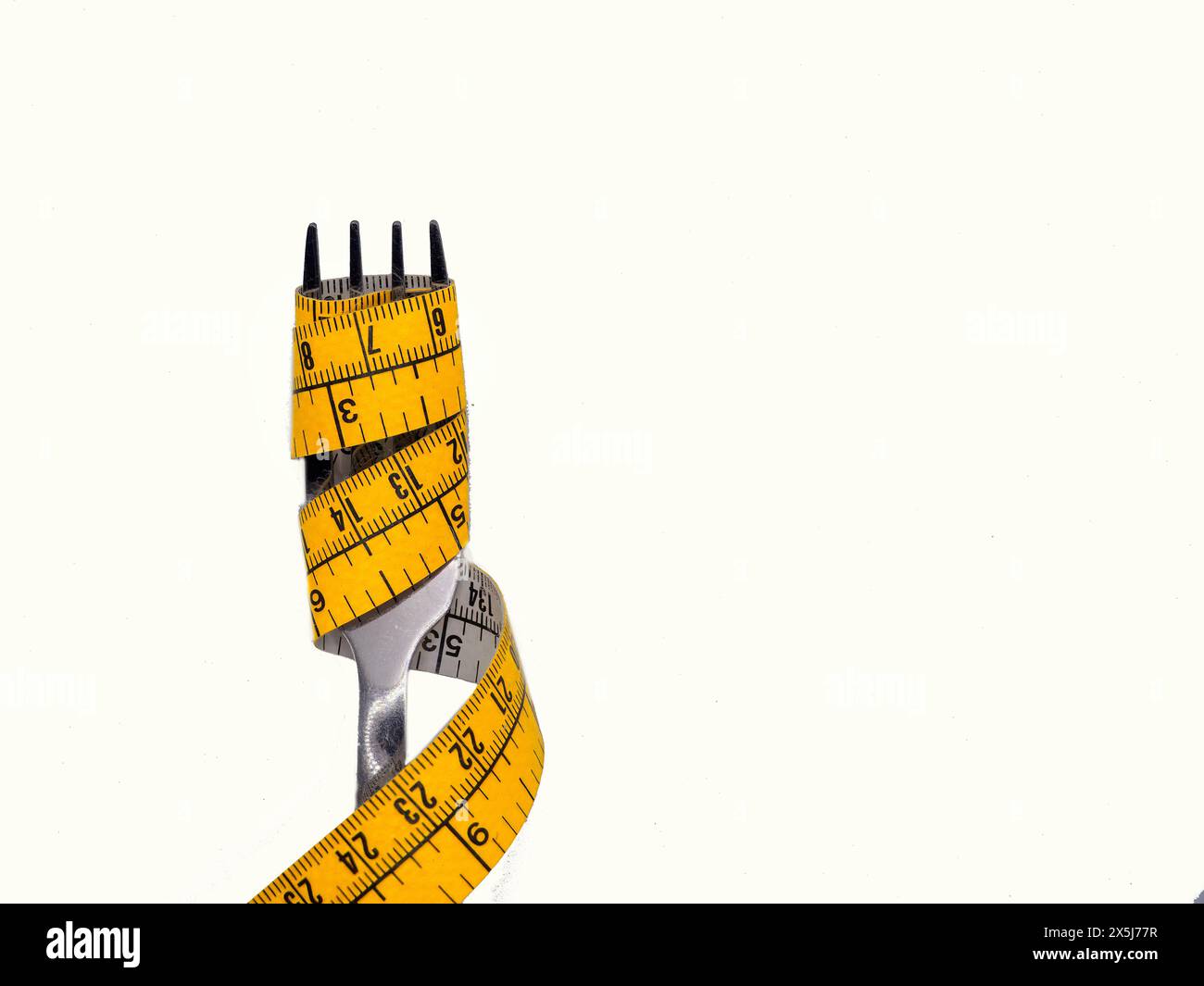 Measuring tape wrapped around fork on a white background, concept of ...