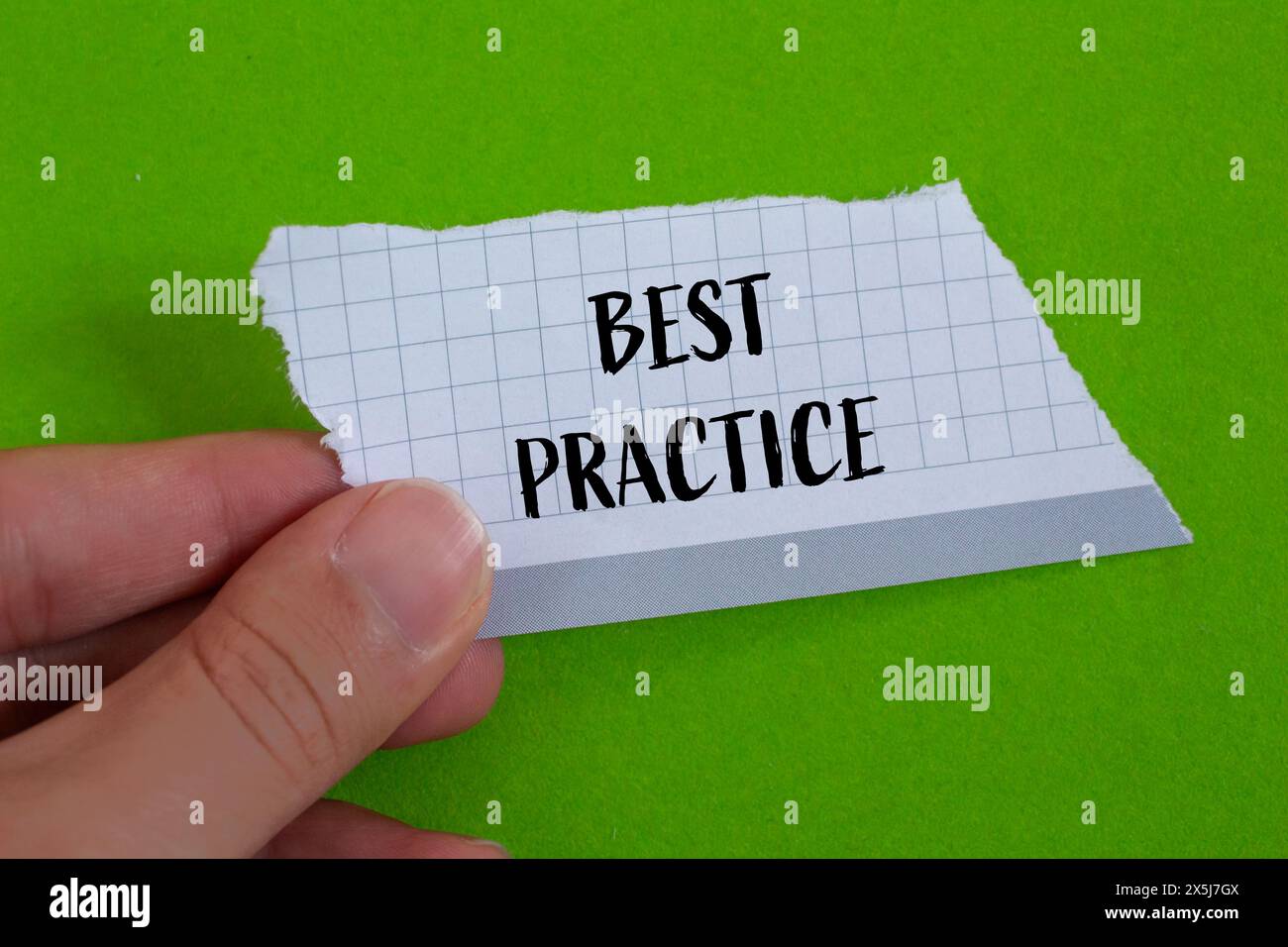 Best practice words written on ripped paper with green background ...