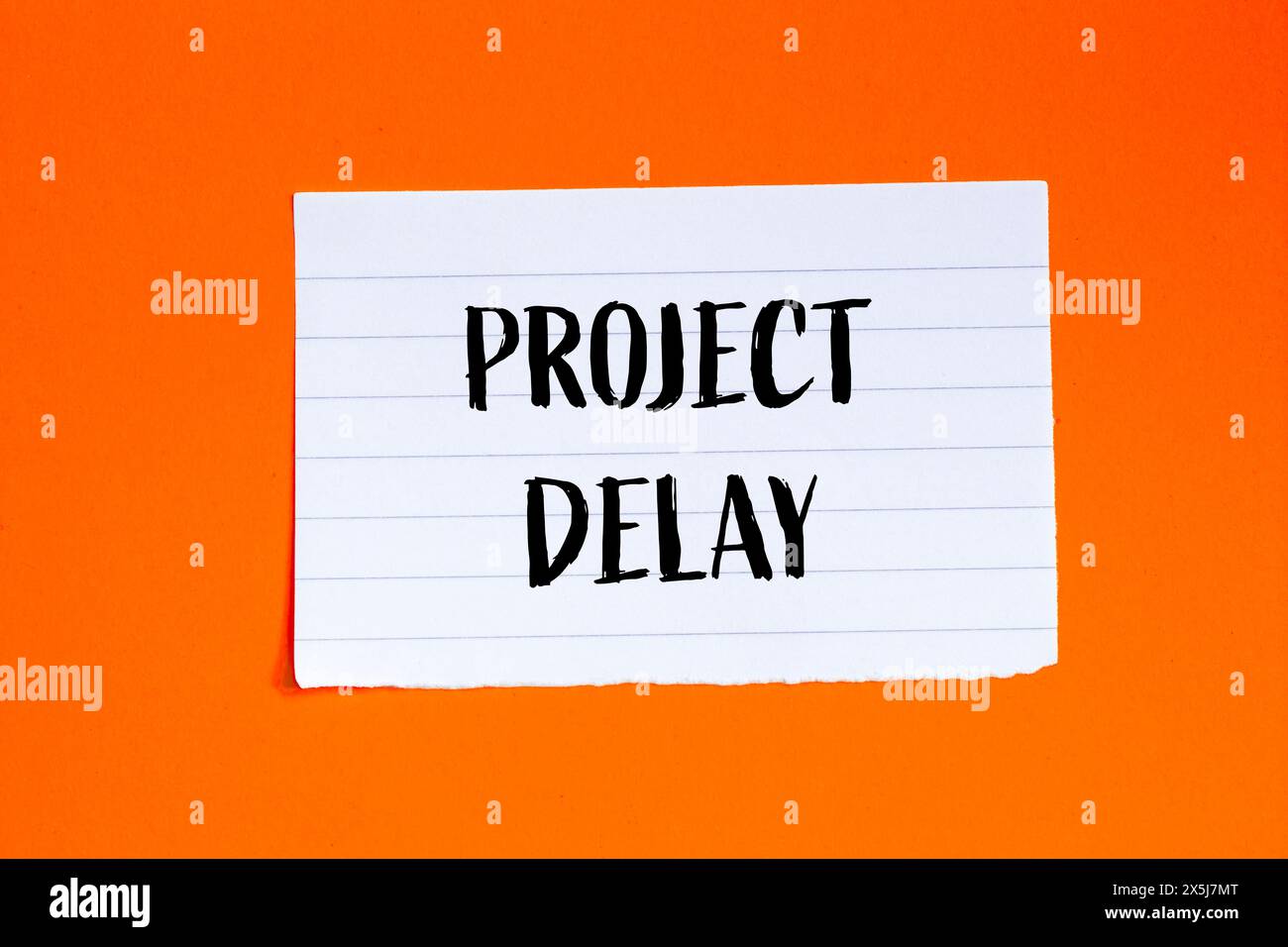 Project delay words written on torn paper with orange background ...