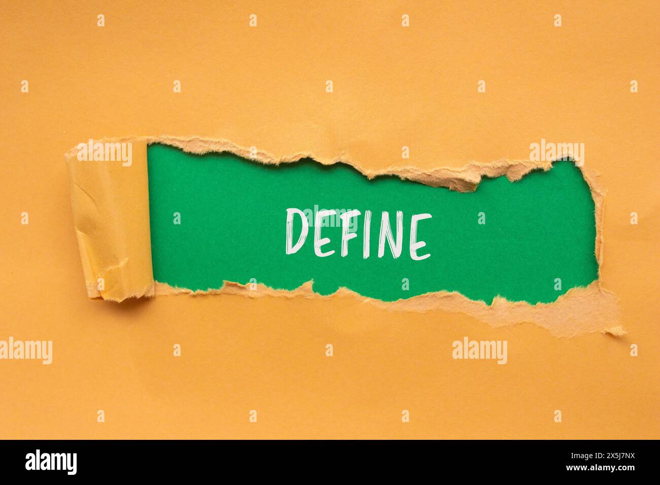 Define word written on torn orange paper with green background ...