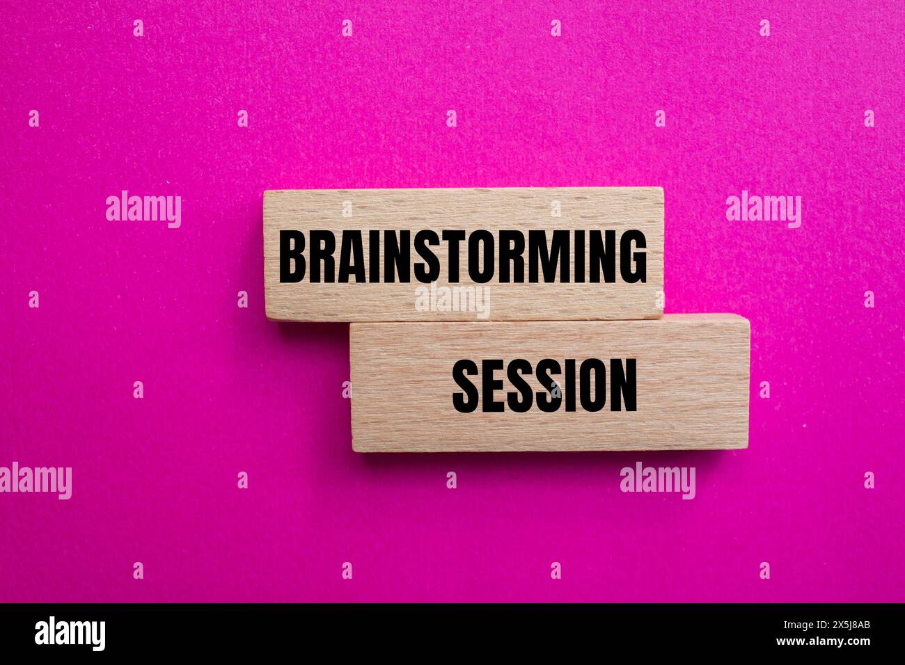 Brainstorming session words written on wooden blocks with pink ...