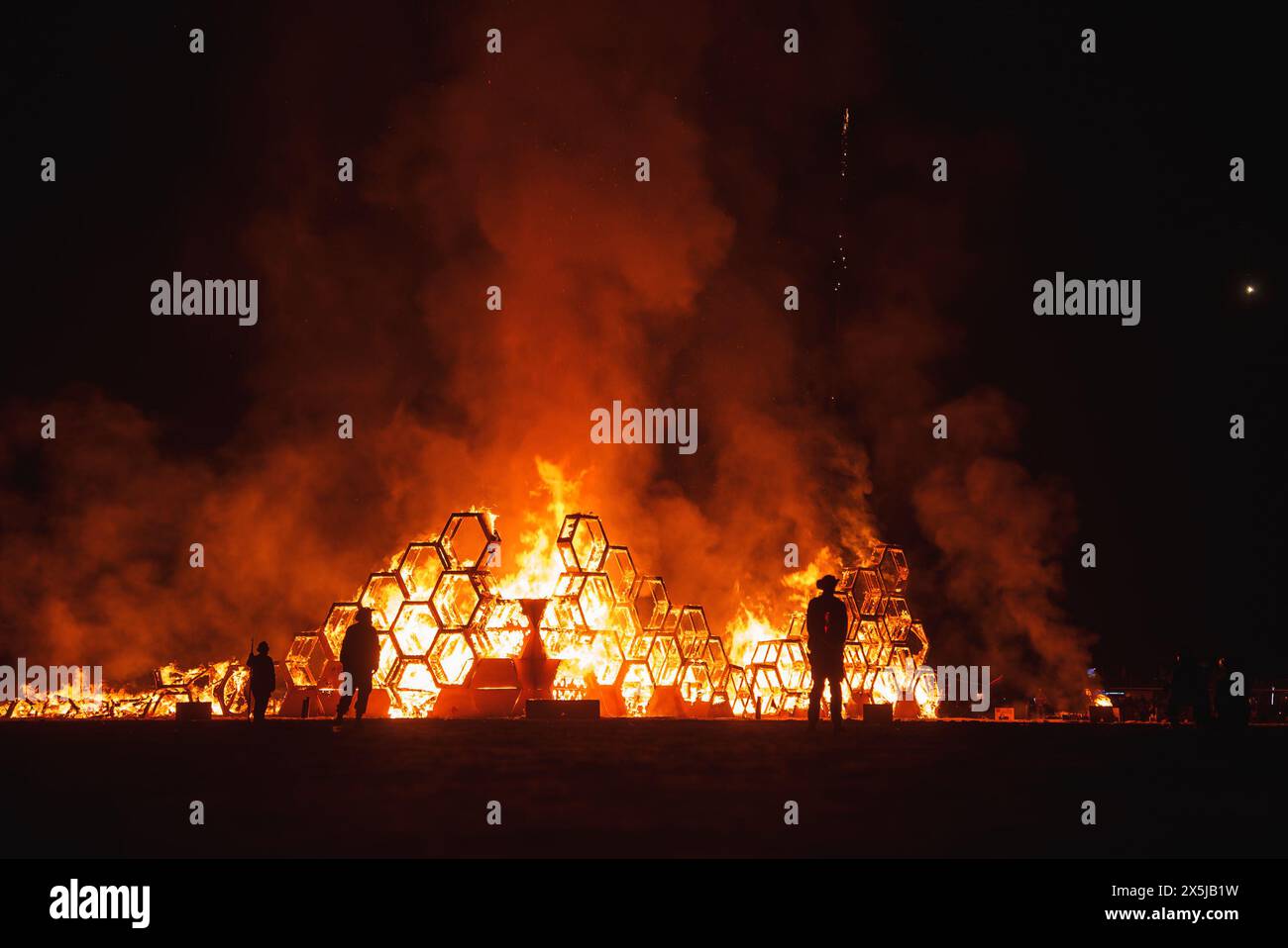 Dramatic Desert Night Scene with Hexagonal Structure Engulfed in Flames ...