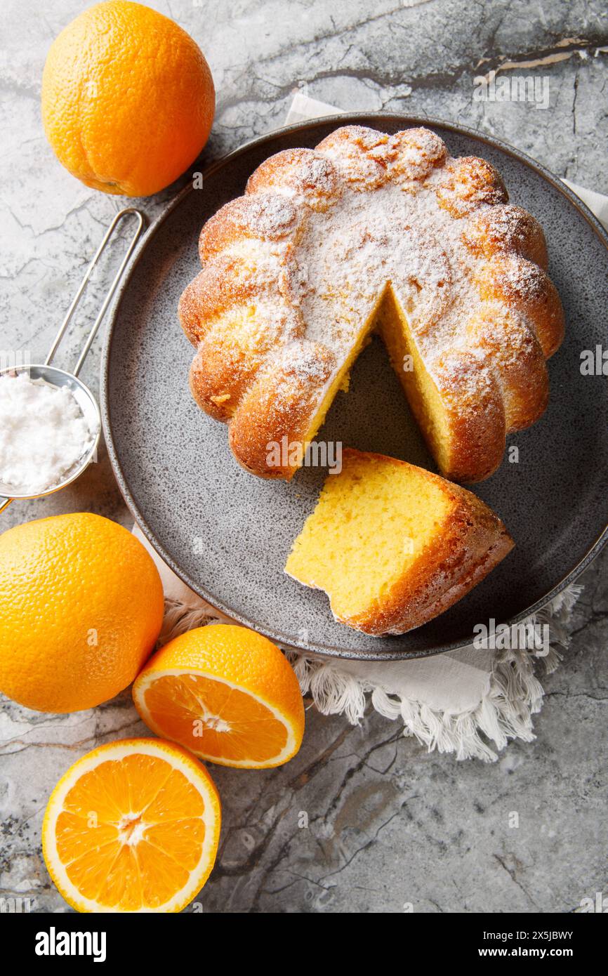 Moroccan Meskouta Orange Cake with powdered sugar close-up on a plate ...