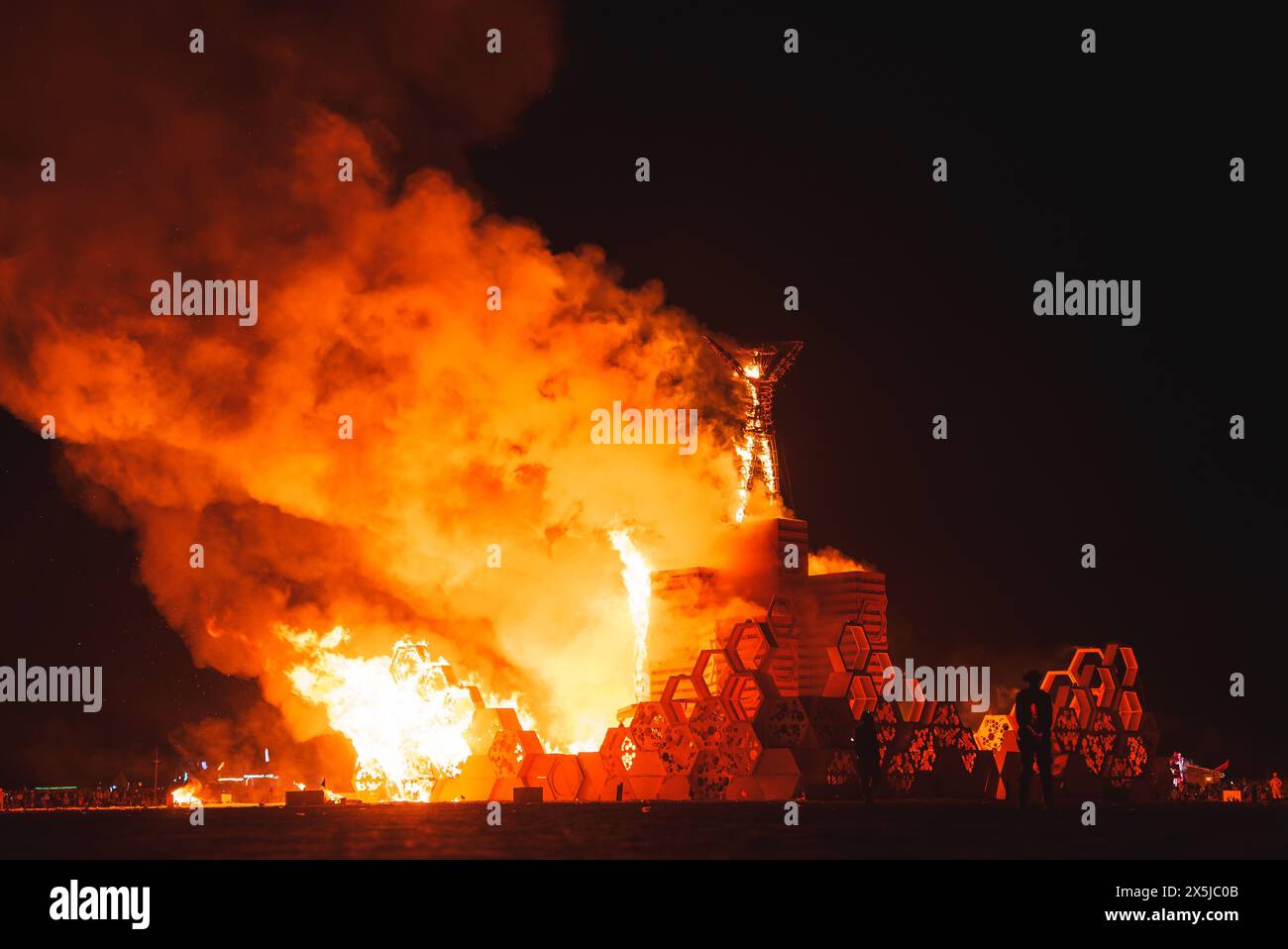 Fiery Blaze Engulfs Wooden Structure in Desert Night Scene Stock Photo ...