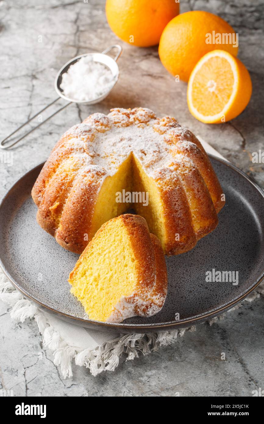 Moroccan Meskouta Orange Cake with powdered sugar close-up on a plate ...