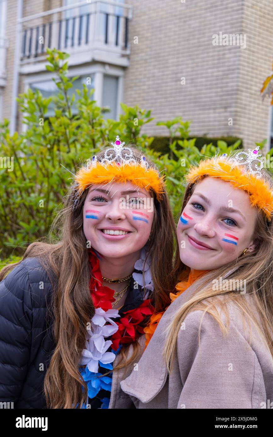 Netherlands, Utrecht, Maarssen. Two young women attending the King's ...
