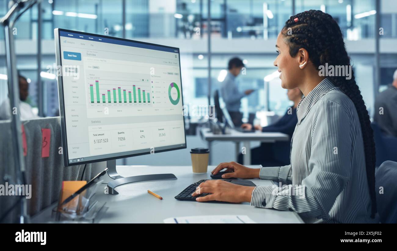 Businesswoman working on graphs smiling hi-res stock photography and ...