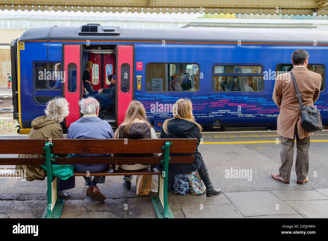 Train passengers / commuters in the UK are pictured waiting on a ...
