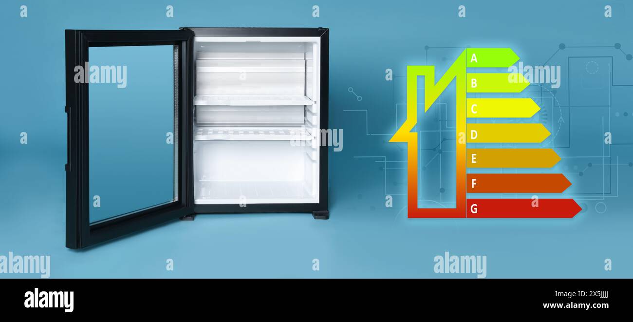 Energy efficiency rating label and refrigerator on light blue ...