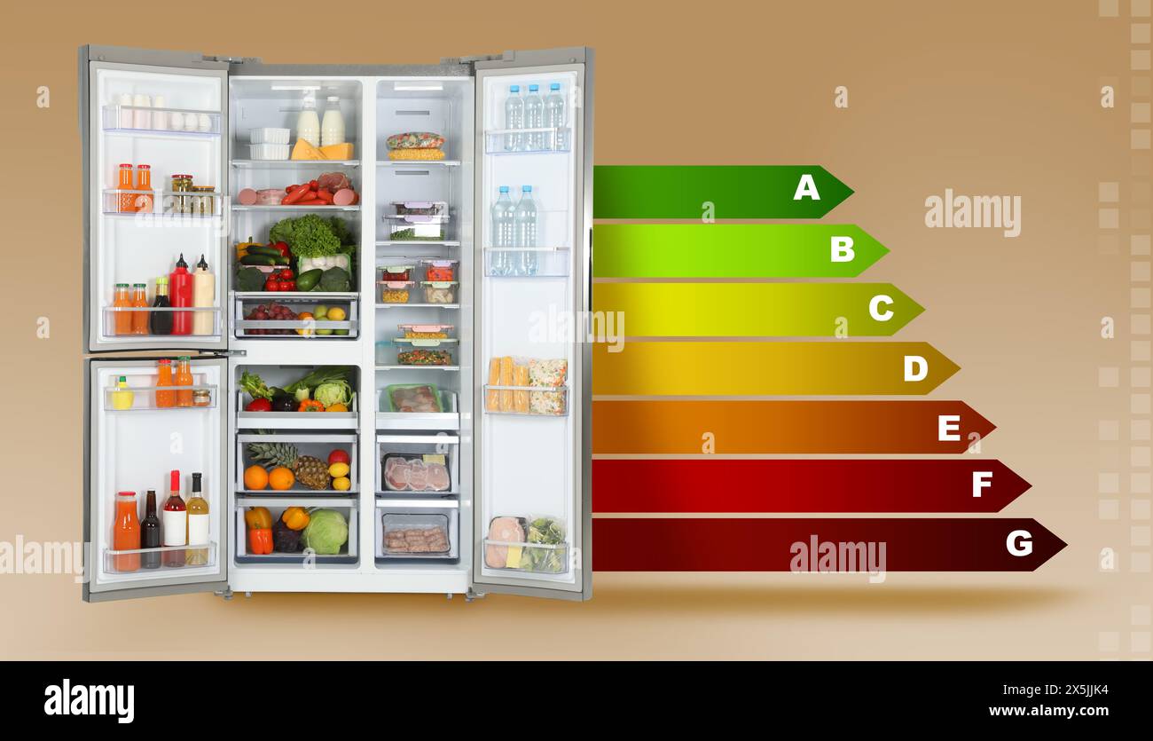 Energy efficiency rating label and open refrigerator on beige ...