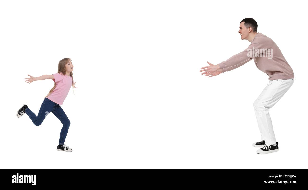 Happy girl running towards her father on white background Stock Photo ...