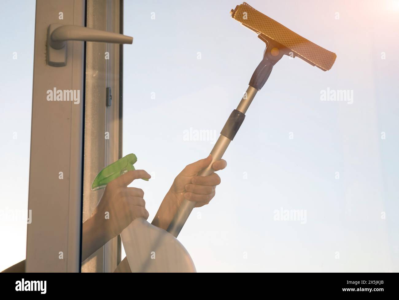 Cleaning window pane with detergent and mop. housework Stock Photo - Alamy