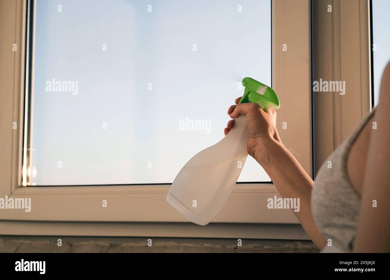 woman washing window with spray. cleaning the glass Stock Photo - Alamy
