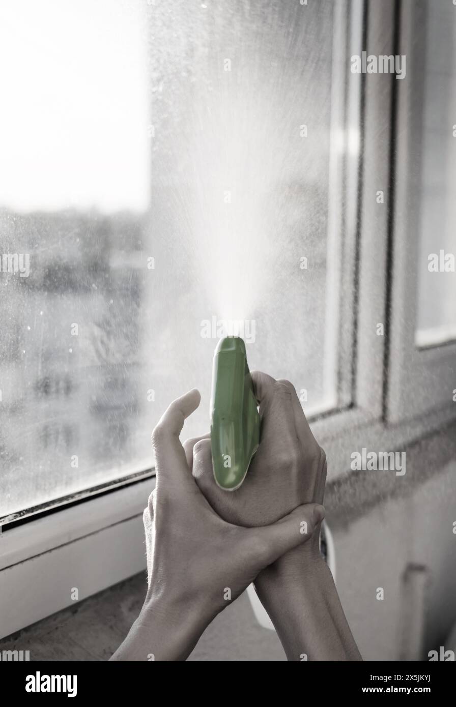 Hand of woman washing window spray, domestic life Stock Photo - Alamy