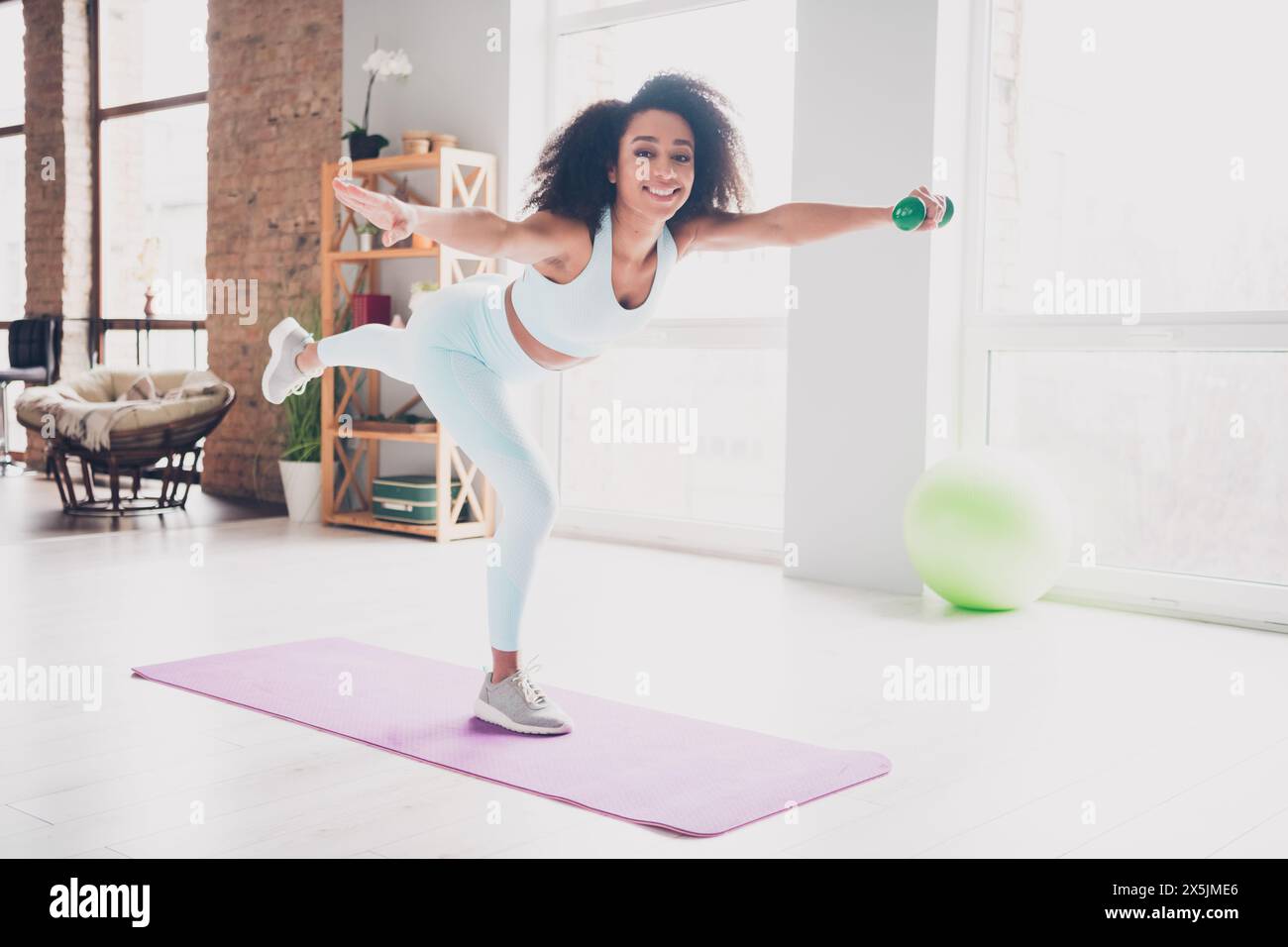 Full length portrait of pretty sportive young girl stand one leg ...