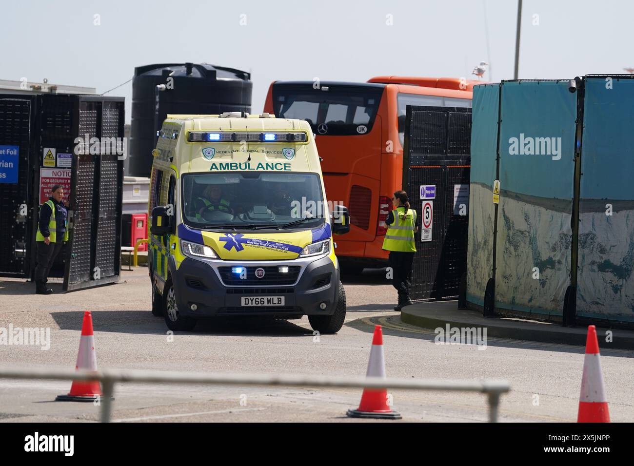 A ambulance leaves under blue lights from the Border Force compound in ...