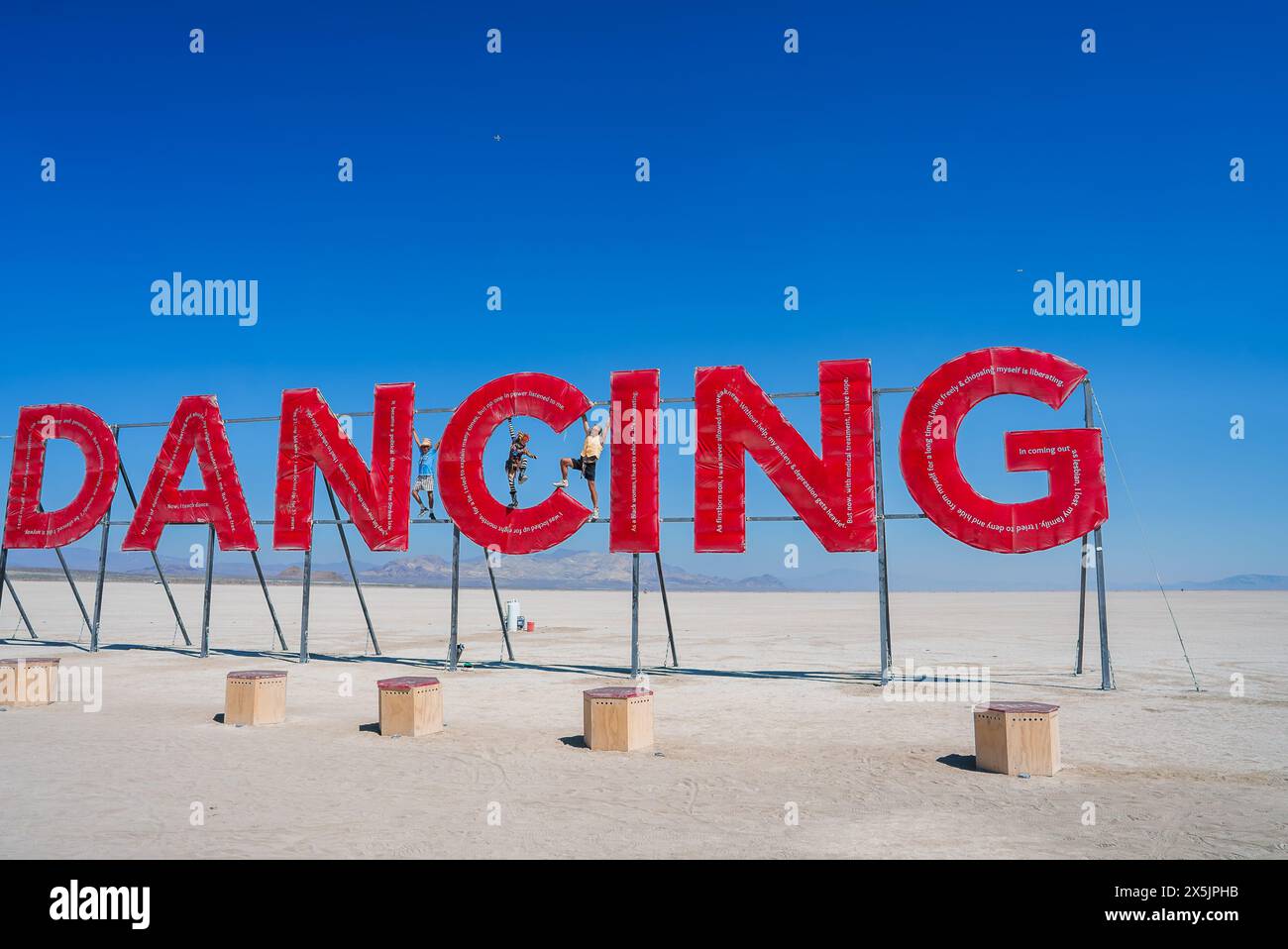 Large Red Dancing Art Installation in Desert Landscape Stock Photo - Alamy
