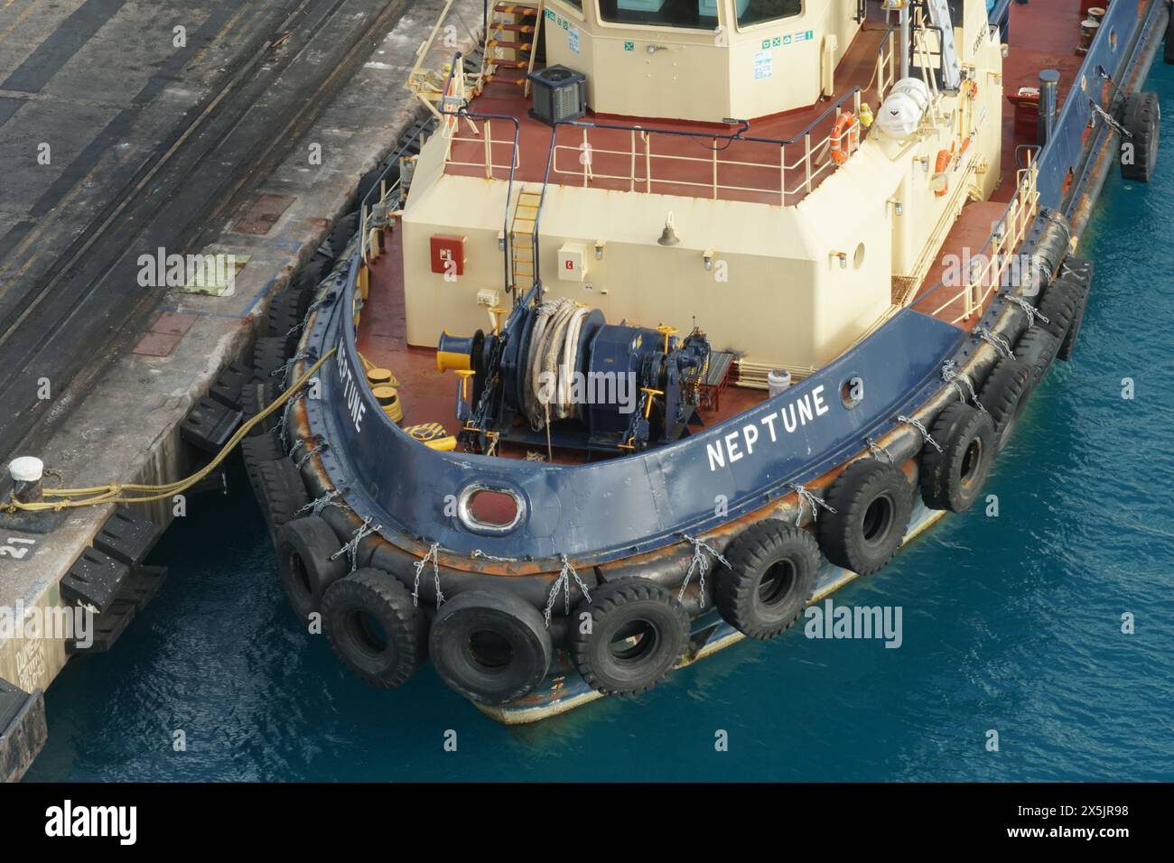 The bow of the tugboat Neptune is visible from above, moored alongside ...