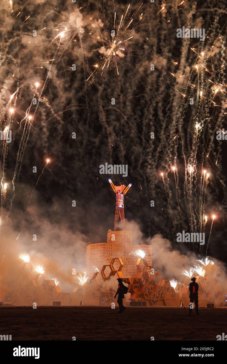 Burning Man festival night scene with effigy, fireworks, and ...