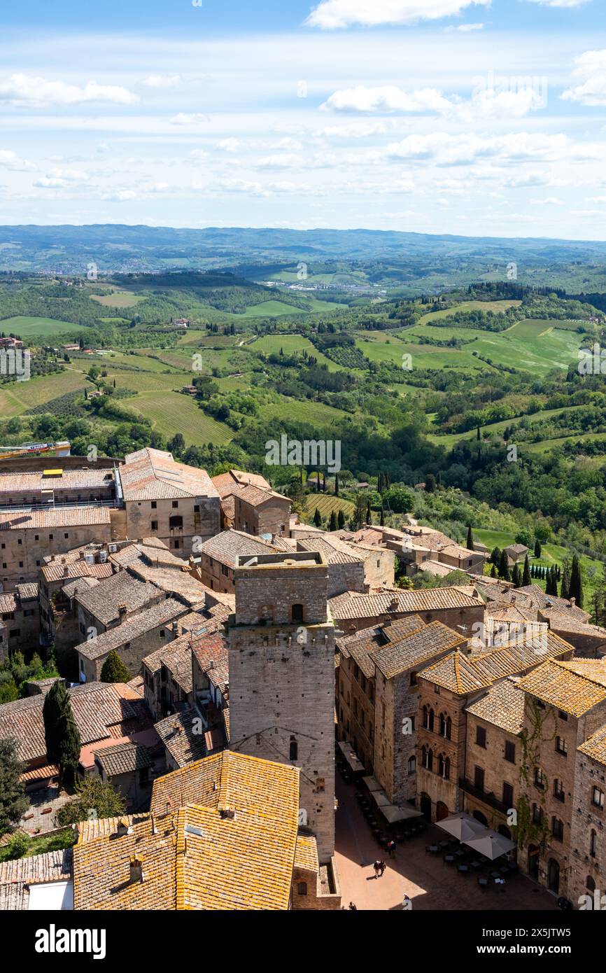 A beautiful view over the rooftops and towers of San Gimignano in ...