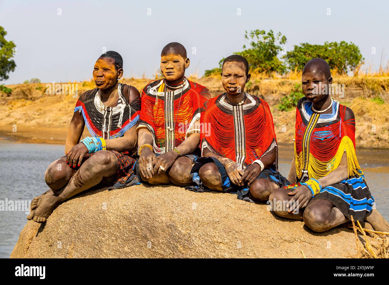 Mundari women in traditional dresses, with facial scarring and ash on ...