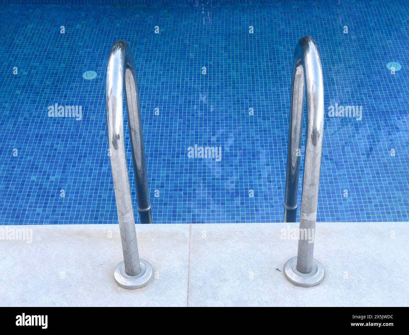 pool, side view chrome ladder of beautiful and clean blue swimming pool ...