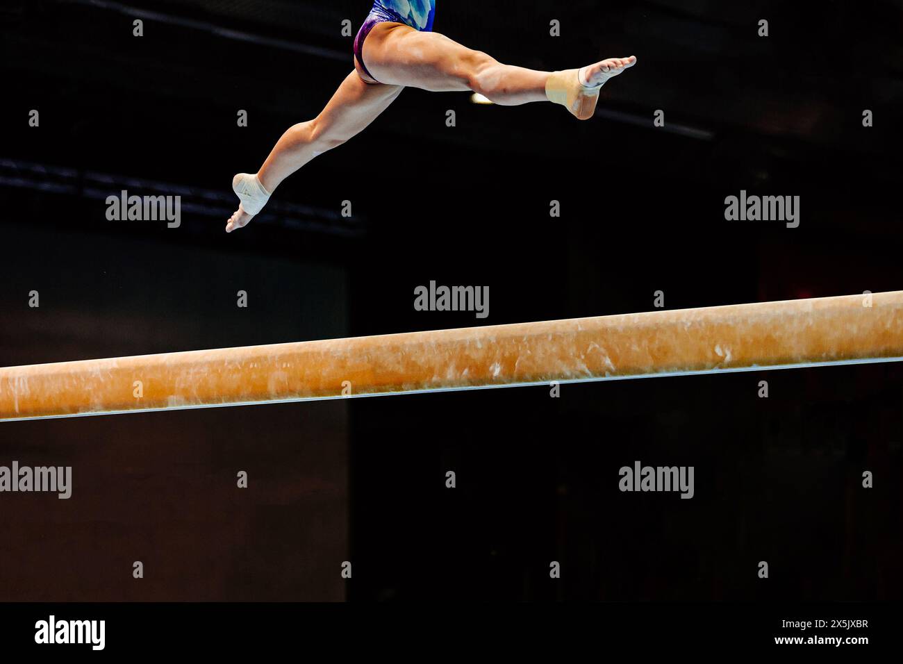 legs woman exercise split jump on balance beam gymnastics in black ...