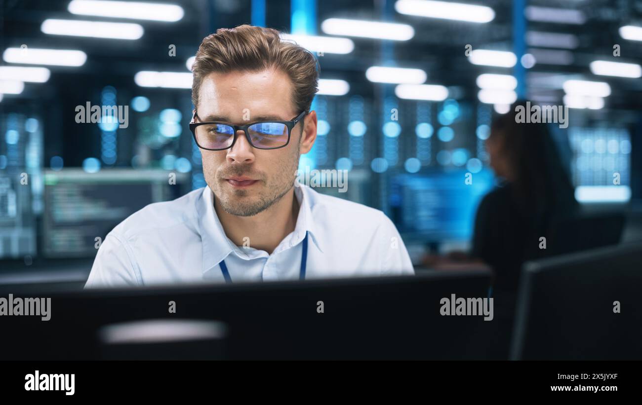 Technical Operator Sits and Monitors Various Activities on Two Computer Displays In the System ...