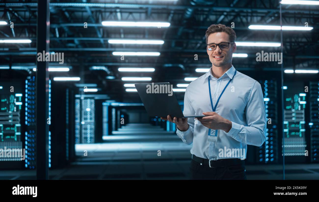 Successful Data Center IT Specialist Using Laptop Computer. Server Farm Cloud Computing Facility ...