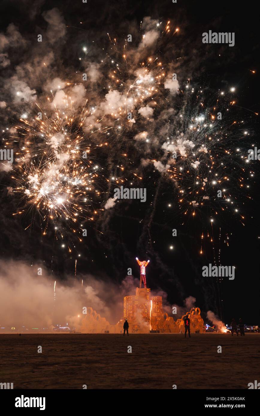 Spectacular nighttime desert festival scene with wooden effigy and ...