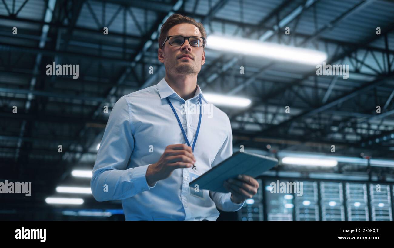 Caucasian Data Center IT Technician Standing at the Server Rack ...
