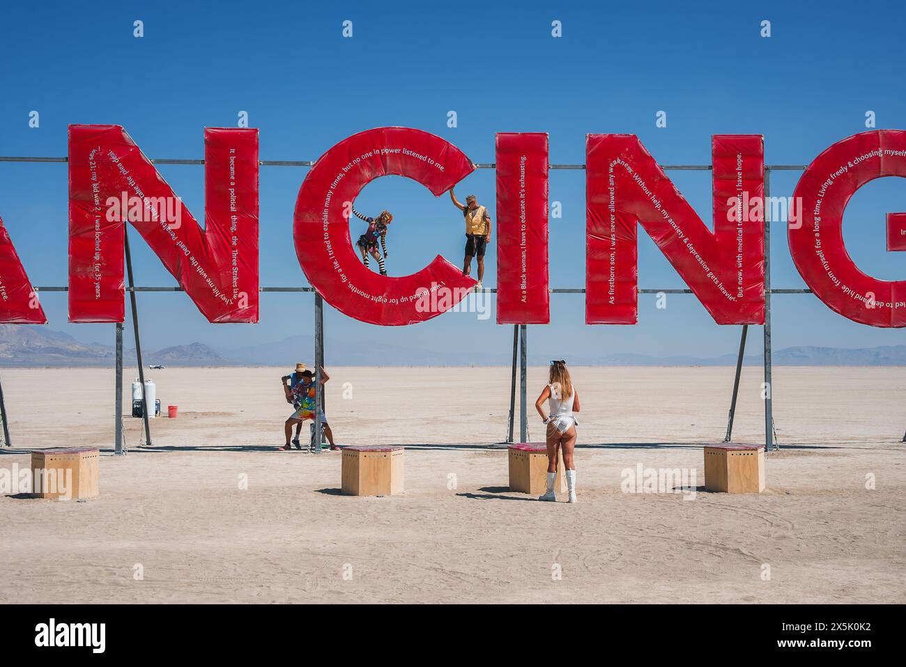 Large Red Dancing Letters Art Installation in Desert Sky Stock Photo ...