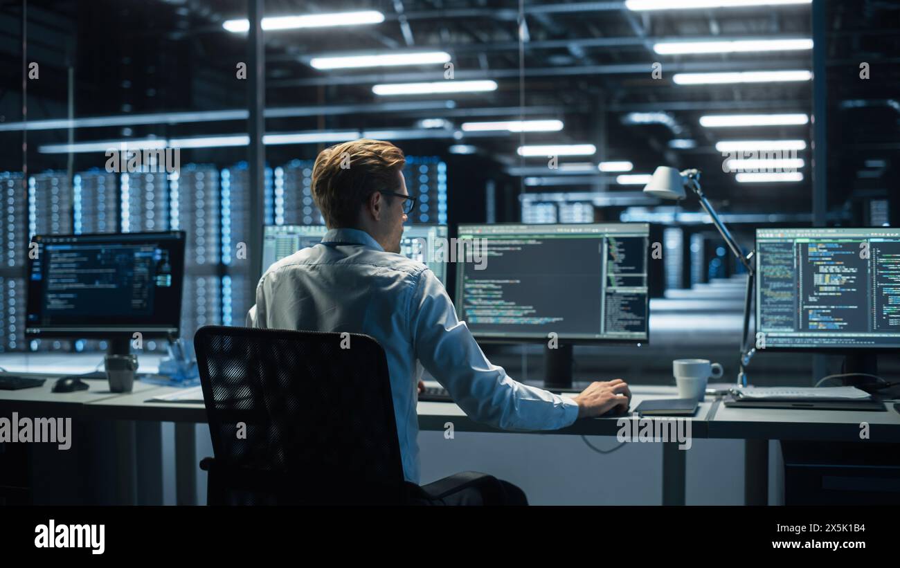 In the System Control Room Technical Operator Sits and Monitors Various ...