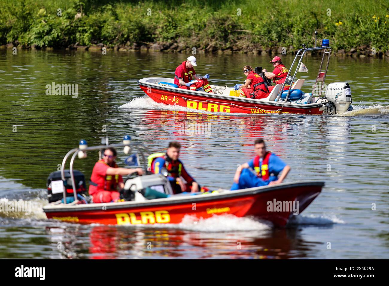 Minden, Germany. 10th May, 2024. Two DLRG motorboats cross a river ...
