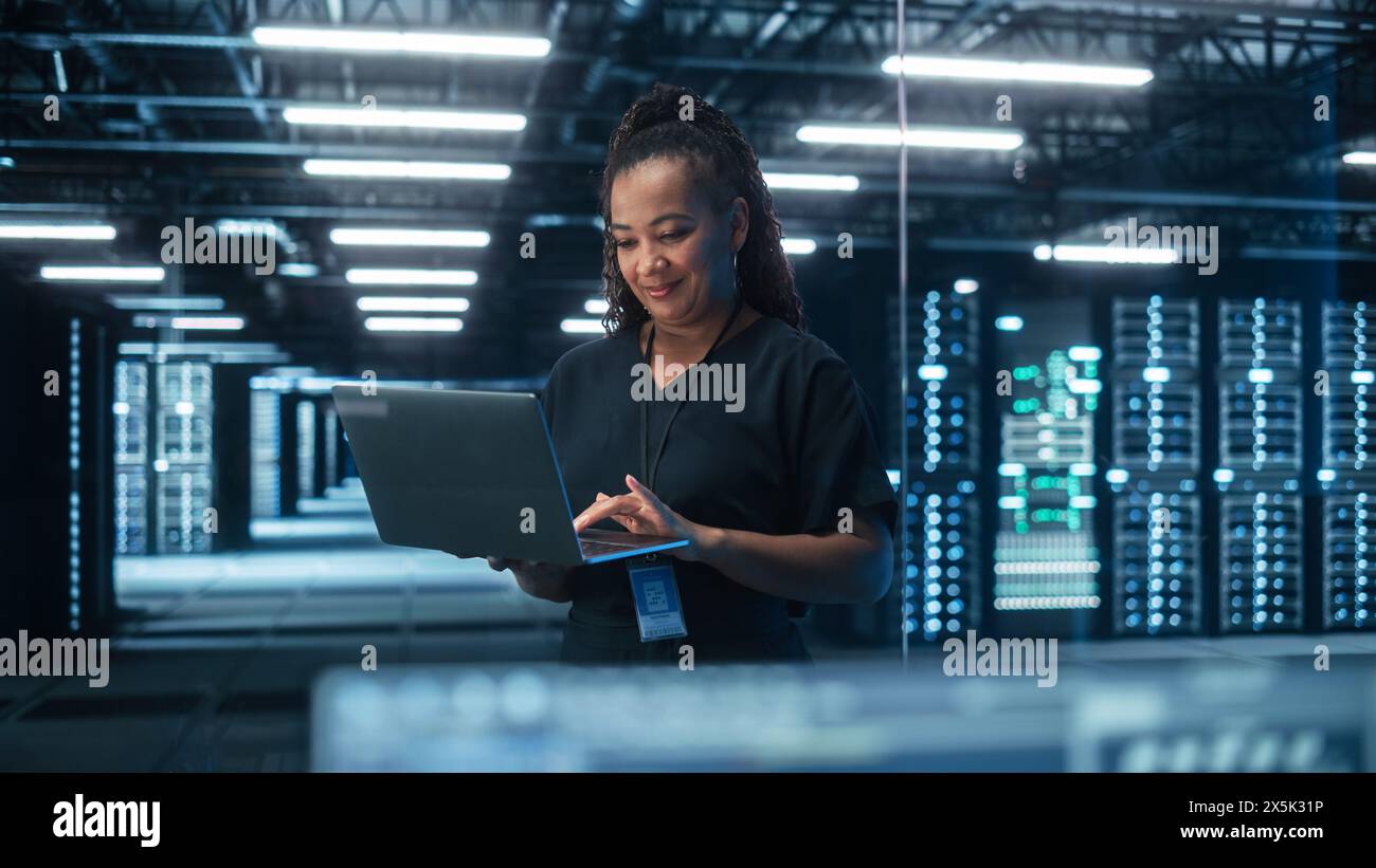 Portrait of Multiracial Mature Female IT Specialist Using Laptop ...