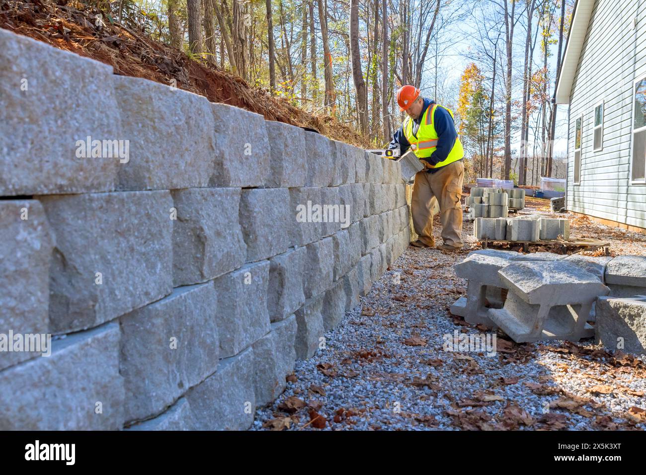 Concrete block retaining wall was mounted by contractor Stock Photo - Alamy