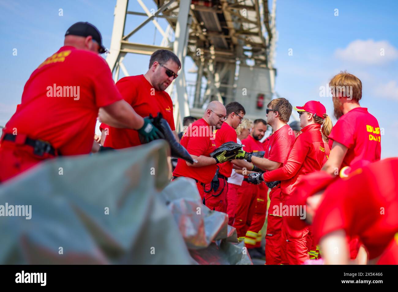 Minden, Germany. 10th May, 2024. DLRK employees pass 20-kilogram ...