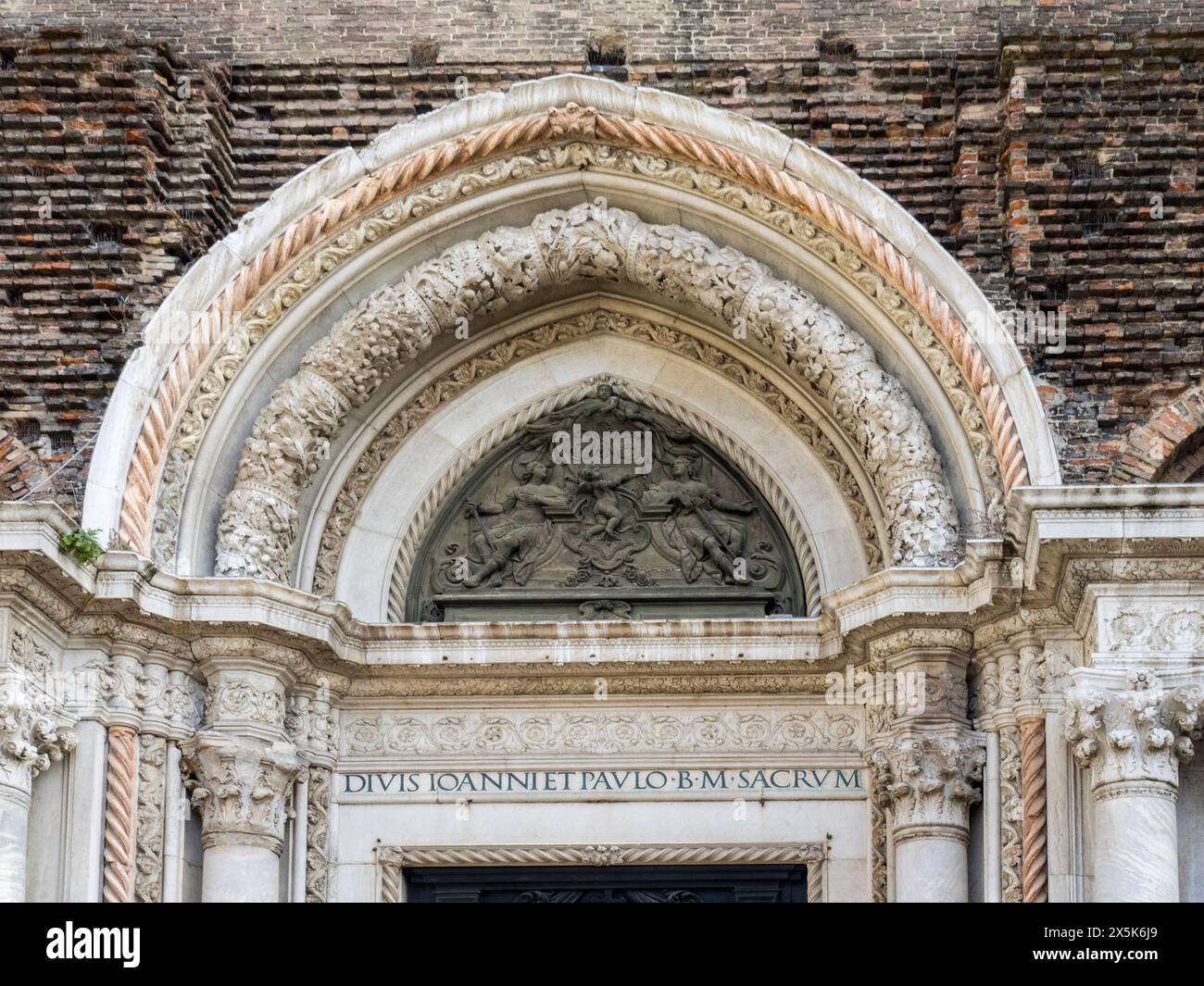 Italy, Venice. Old carving above the doorway of the Basilica dei Santi ...