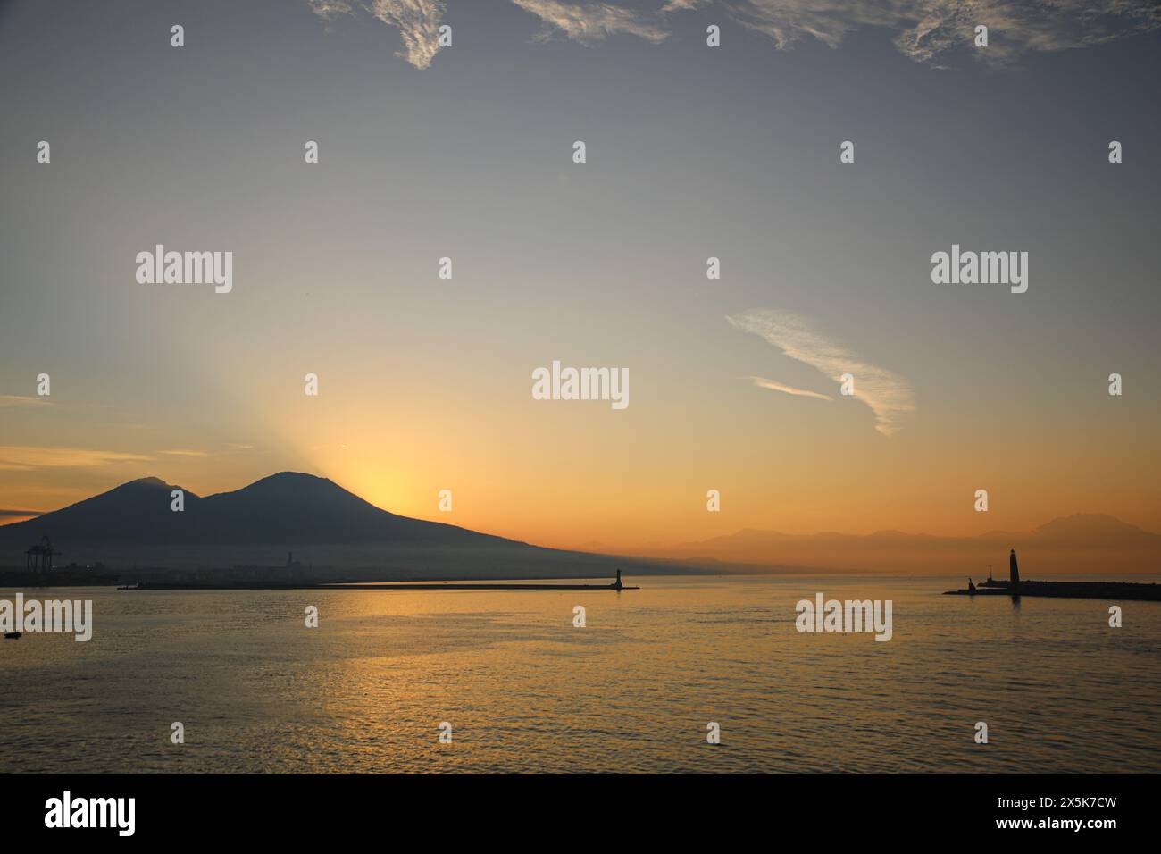 Naples, Italy. Mount Vesuvius, a golden sunrise and lighthouse at the ...