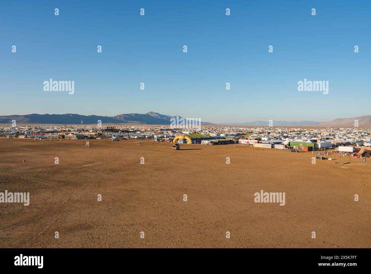 Desert Festival Community in Valley with Mountain Backdrop Stock Photo ...