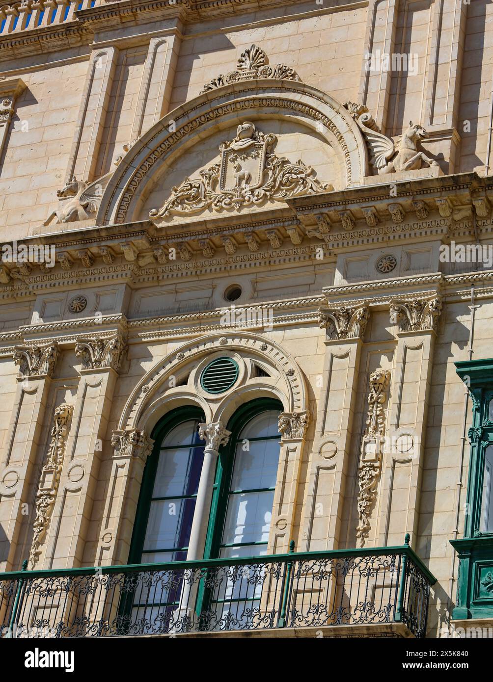 Valletta, Malta. Limestone Maltese building, gothic arched windows ...