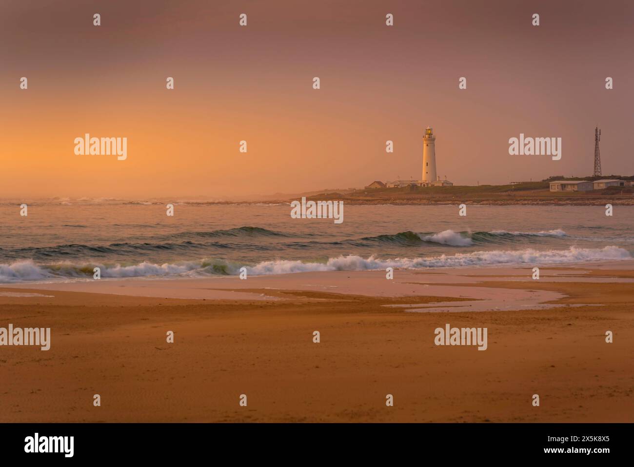 View of beach and Seal Point Lighthouse at sunrise, Cape St. Francis ...