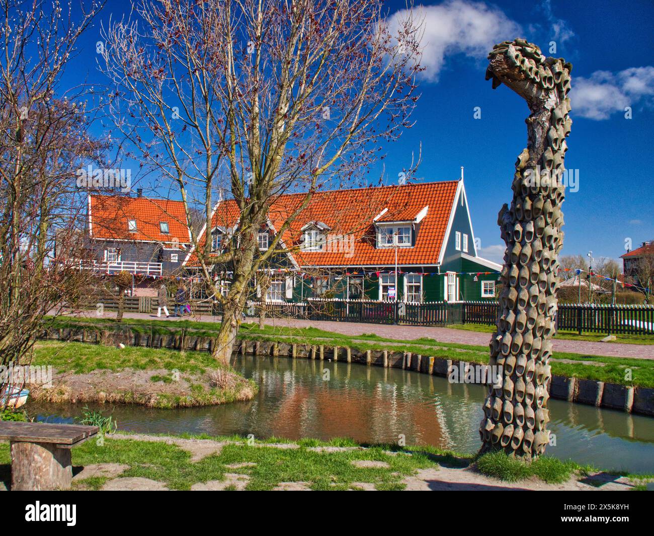 Tall pole decorated with old wooden shoes and typical Dutch houses in ...