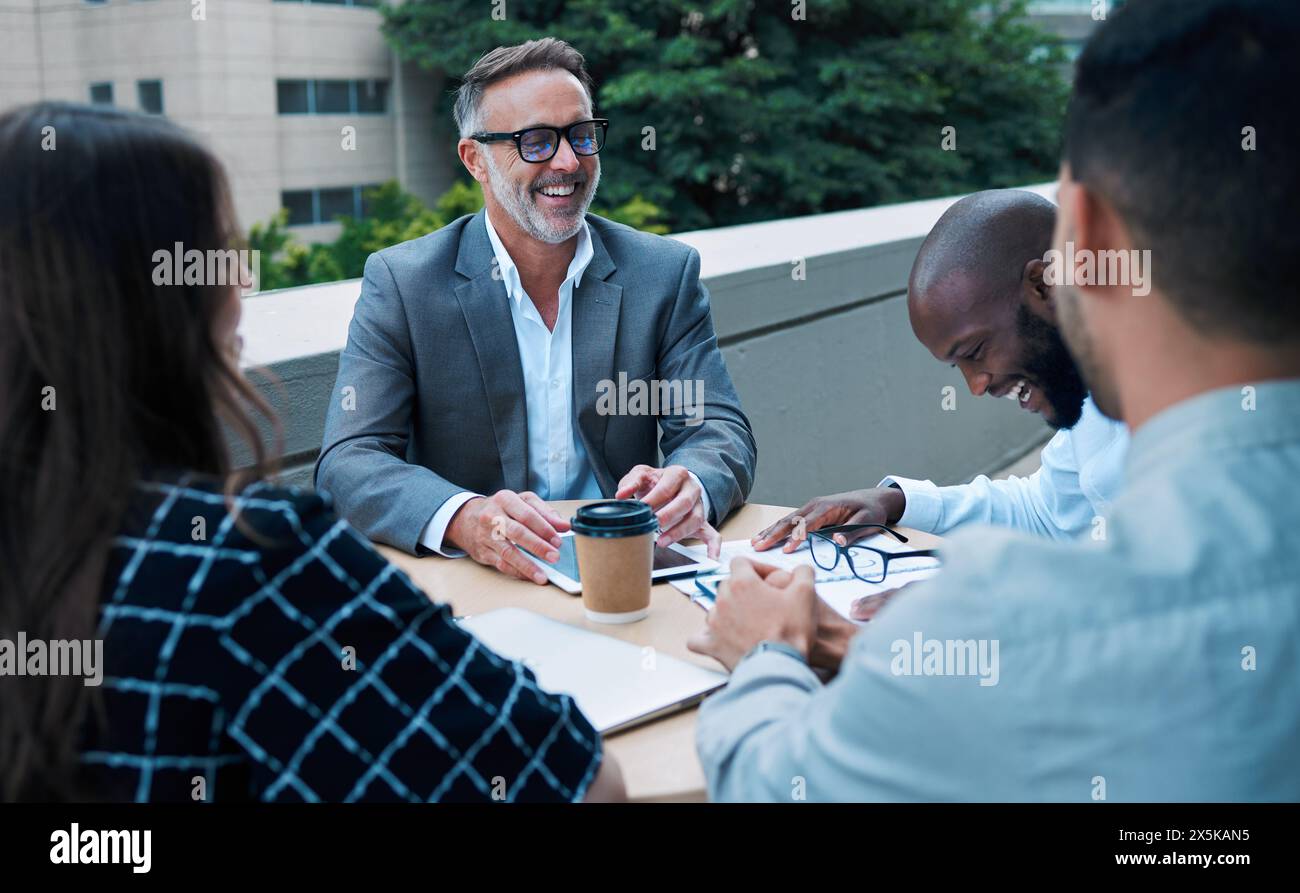 Businesspeople, meeting and outside with smile at table on rooftop for ...