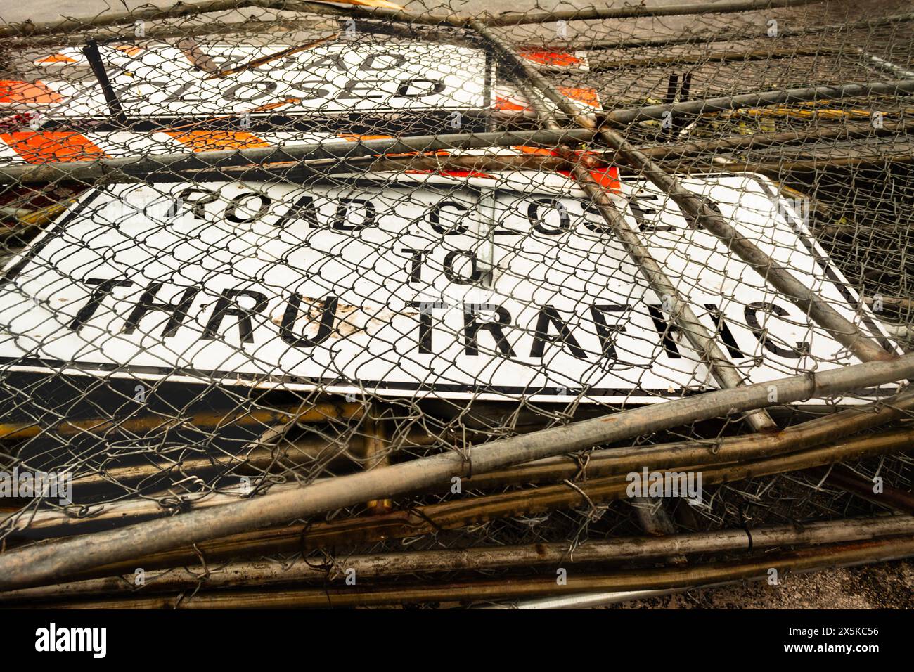 Road Closed to Thru Traffic signs, in a large pile of chain link ...