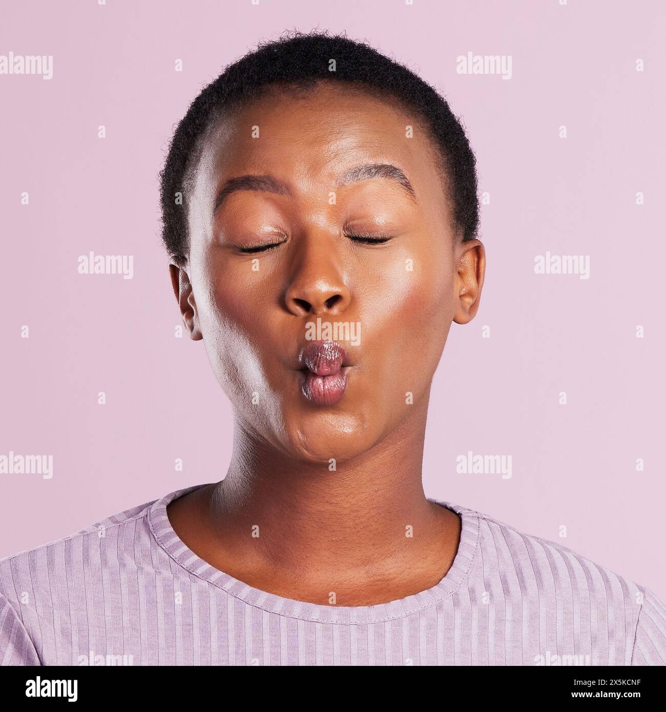 African woman, pout and eyes closed with studio background for emoji or ...
