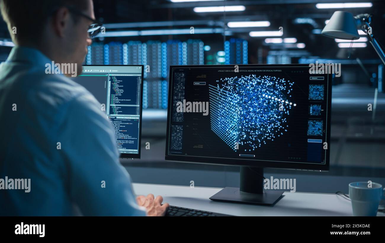 Technical Operator Works at His Workstation with Display Showing Neural ...
